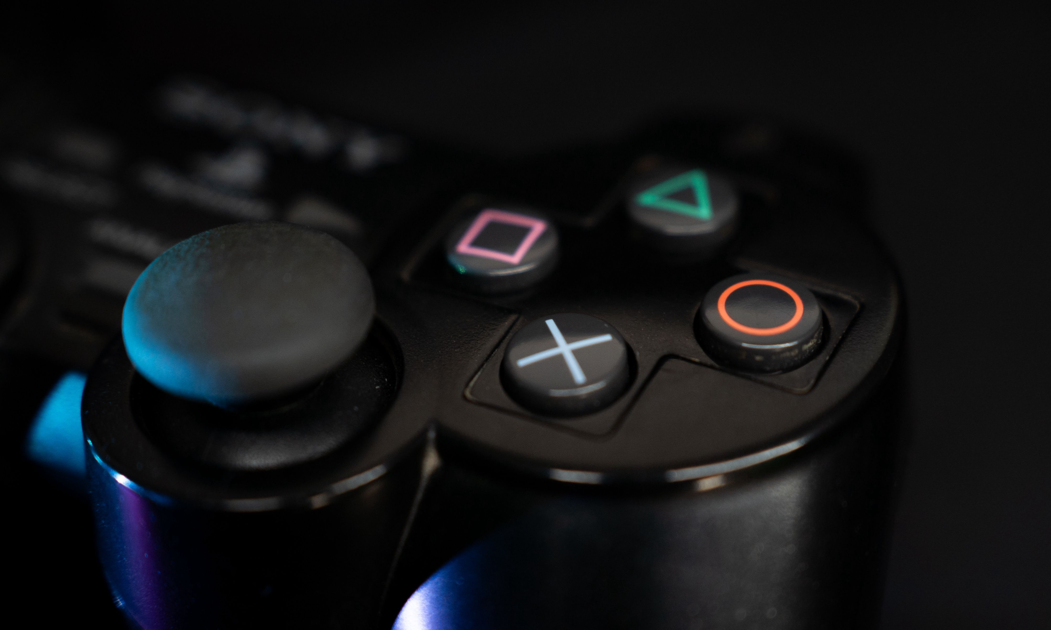 A close up photo of a Playstation 2 controller’s facebuttons.