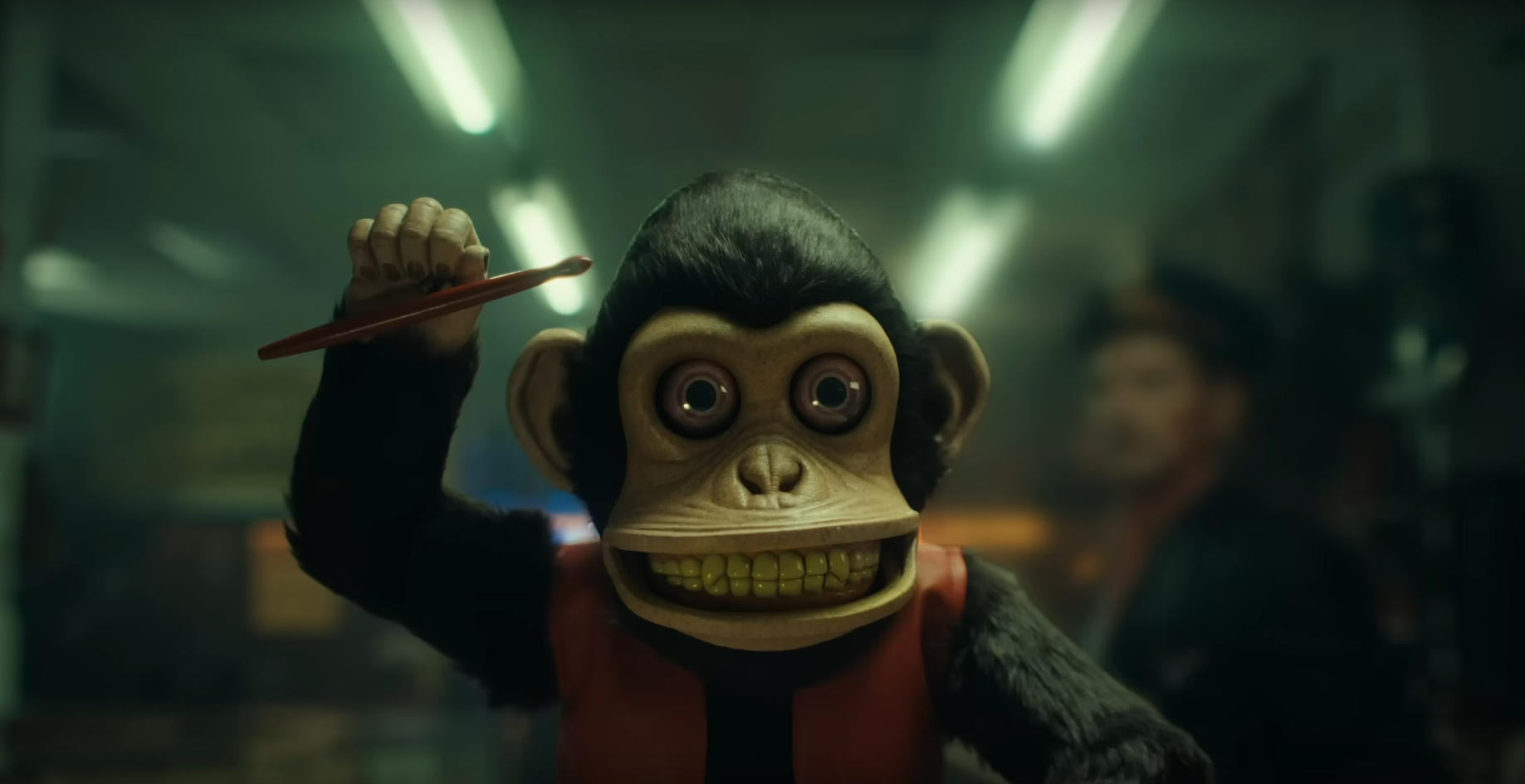 The toy monkey from the movie 'The Monkey' raises a hand to play its drum.