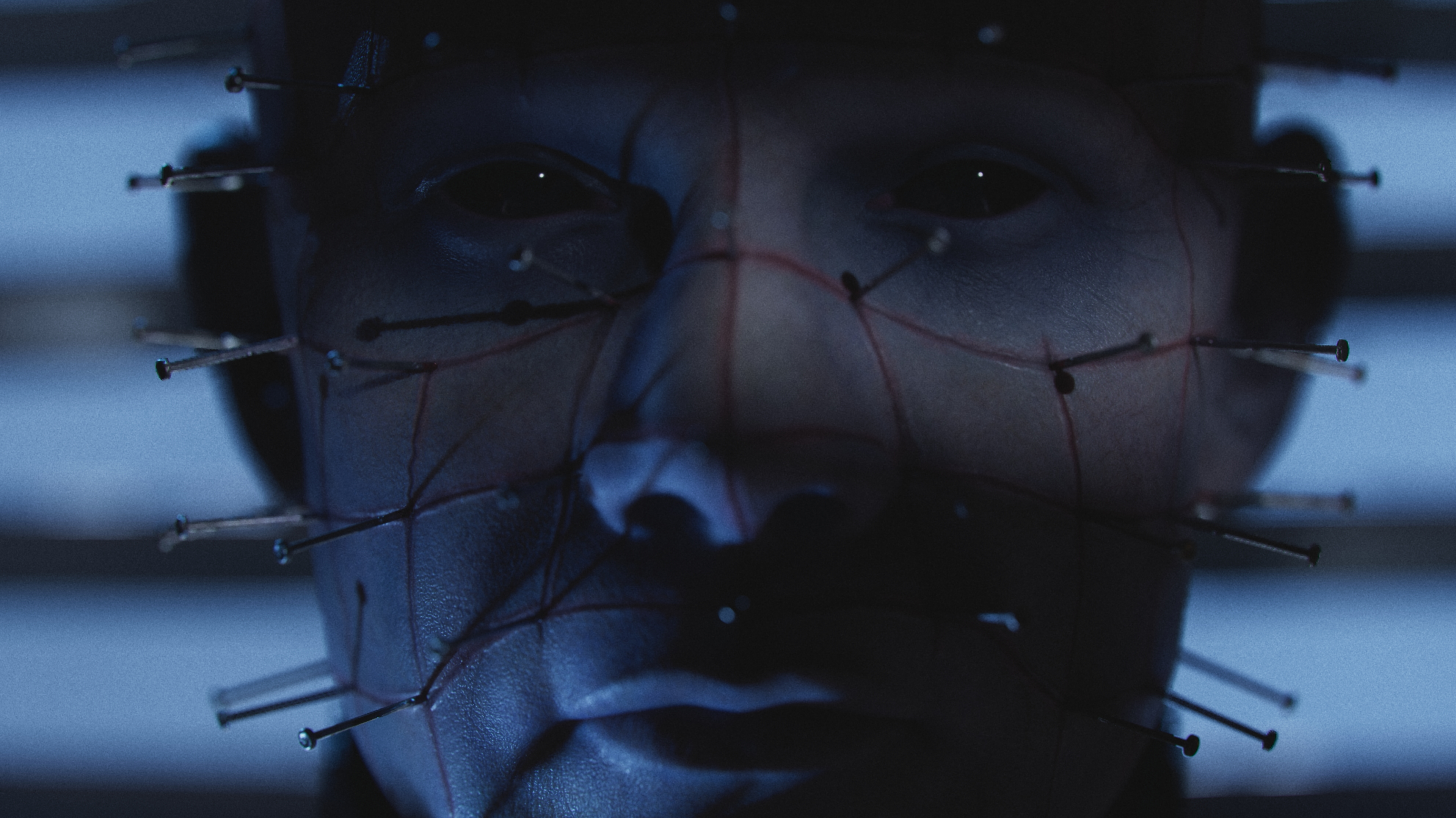 A close-up shot of Pinhead’s face from Clive Barker’s Hellraiser: Revival