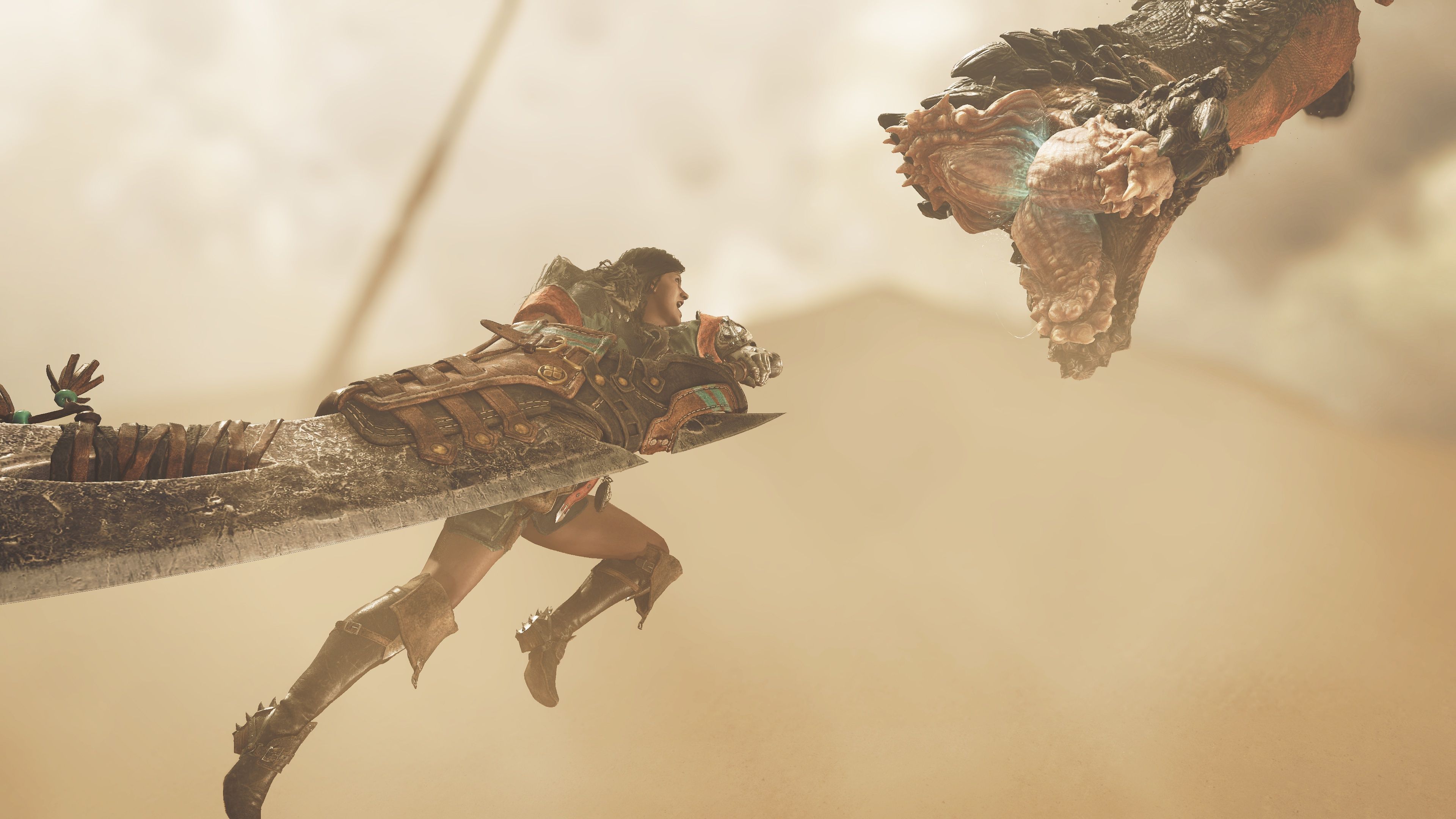 A player character in Monster Hunter Wilds lunges with a massive weapon towards a huge monster in a desert wasteland